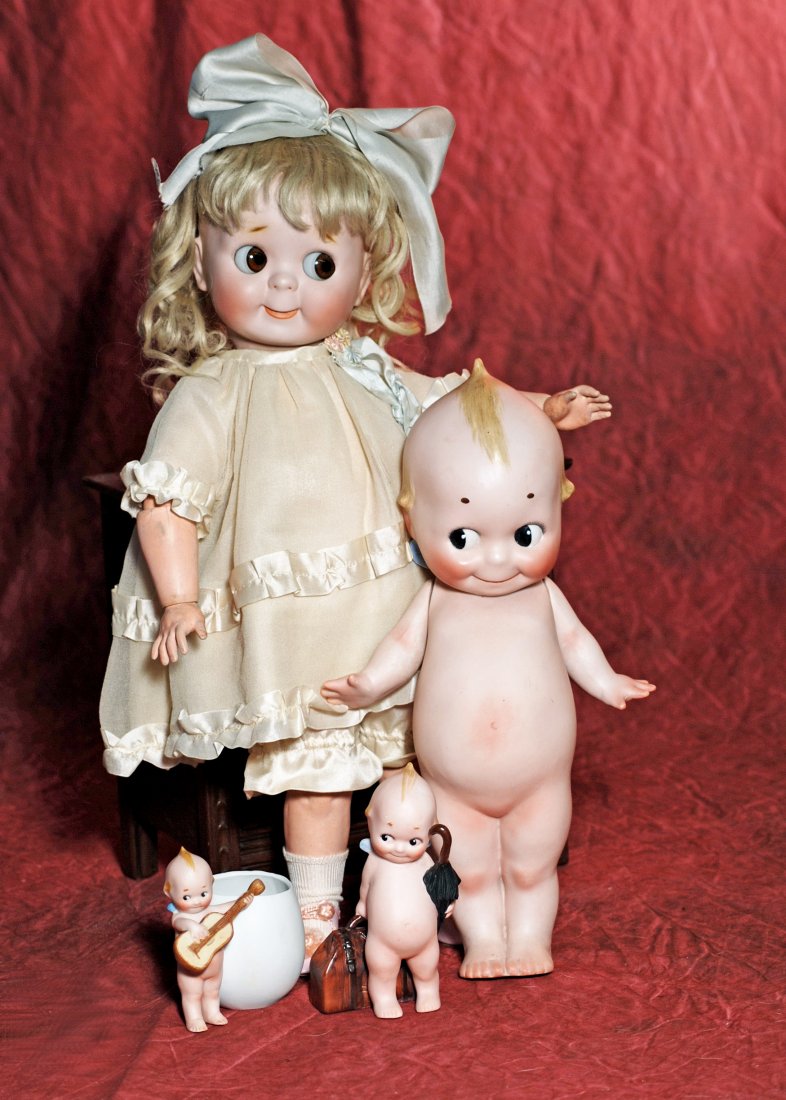 GERMAN BISQUE KEWPIE WITH GUITAR AND EASTER EGG CANDY