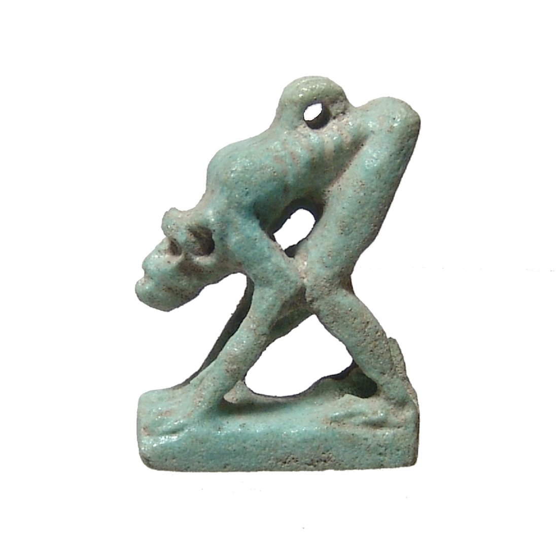 Egyptian faience amulet of an emaciated monkey