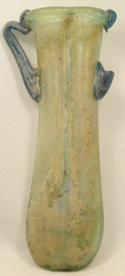 A Roman glass two-compartment cosmetic container