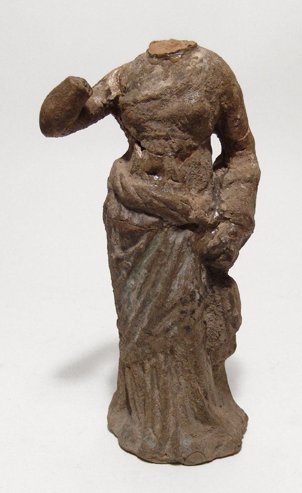 A Greek Tanagra figure of a robed woman