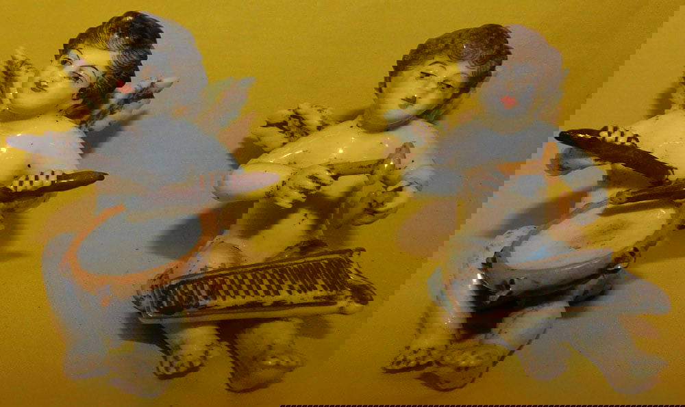 Two Dresden Porcelain Cupid Figurines Auction