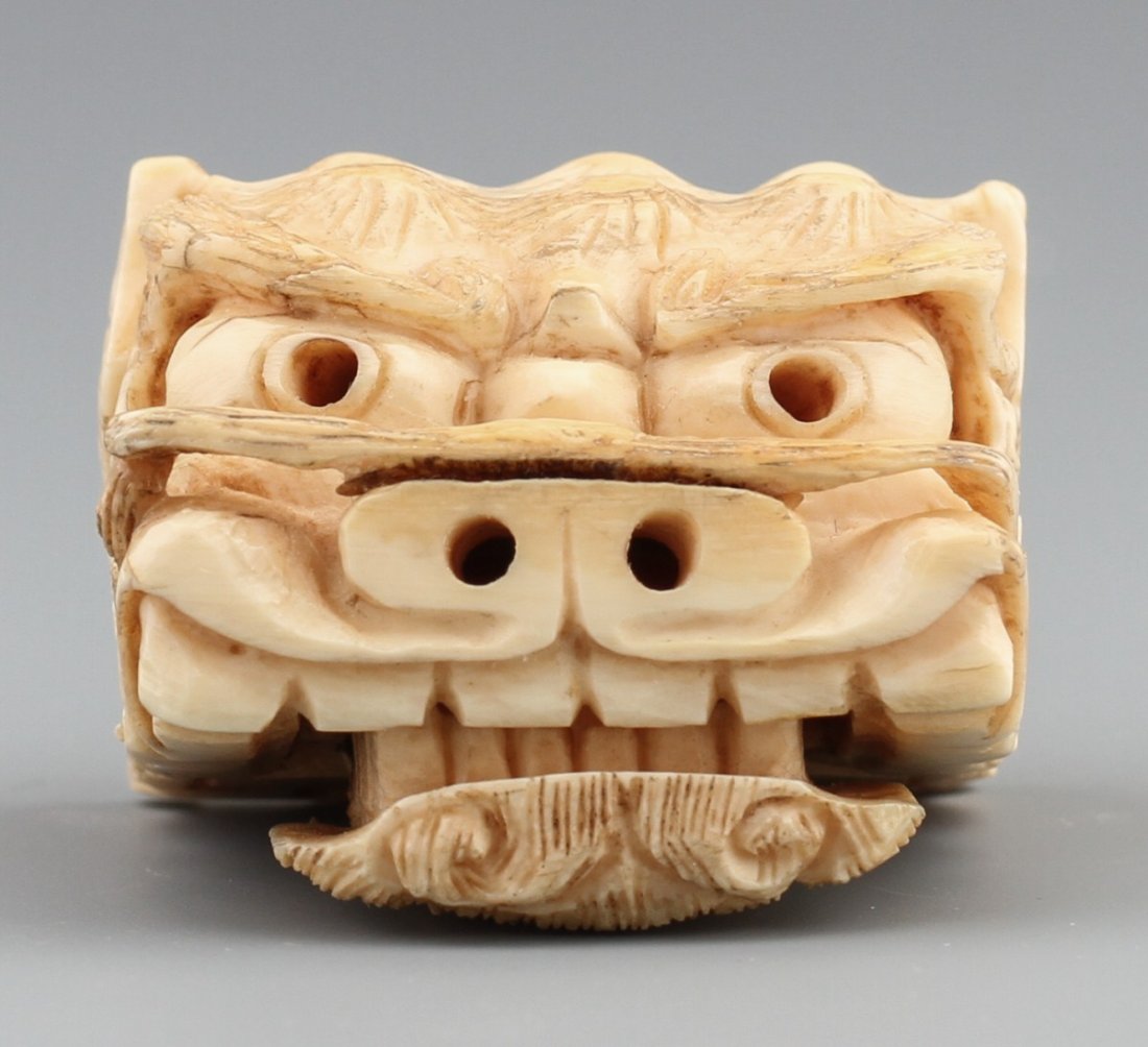 JAPANESE CARVED IVORY FOO DOG KARAKURI-NETSUKE