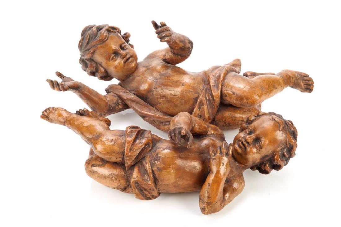 Pair of antique carved wood putti figures