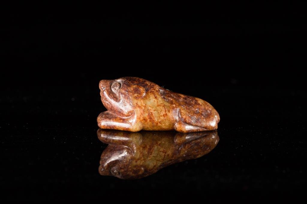 A YELLOW TO RUSSET RED JADE BOAR CARVING