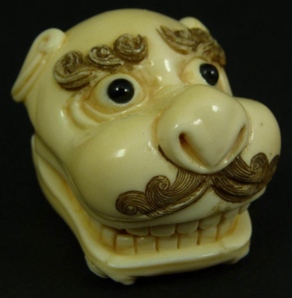 CARVED IVORY HIDDEN SCENE FOO DOG HEAD NETSUKE