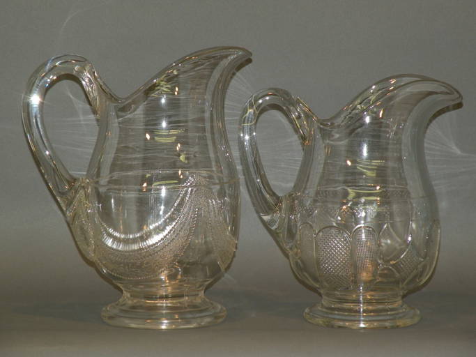 2 Colorless Pattern Glass Pitchers