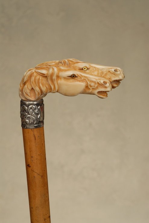 A great carved ivory cane of racing horses