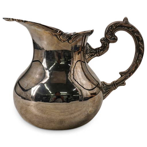 Peruvian Sterling Silver Water Pitcher With An Attached Ornate Handle