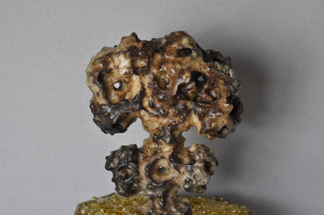A CHINESE BURNT JADE SCULPTURE