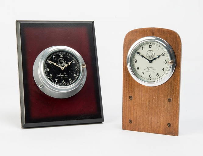 Michelin: A Pair Of 6 Volt Dashboard Clocks Mounted On