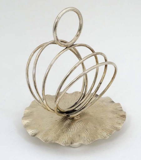A Silver Plate 4 Slice Toast Rack On Shaped Circular