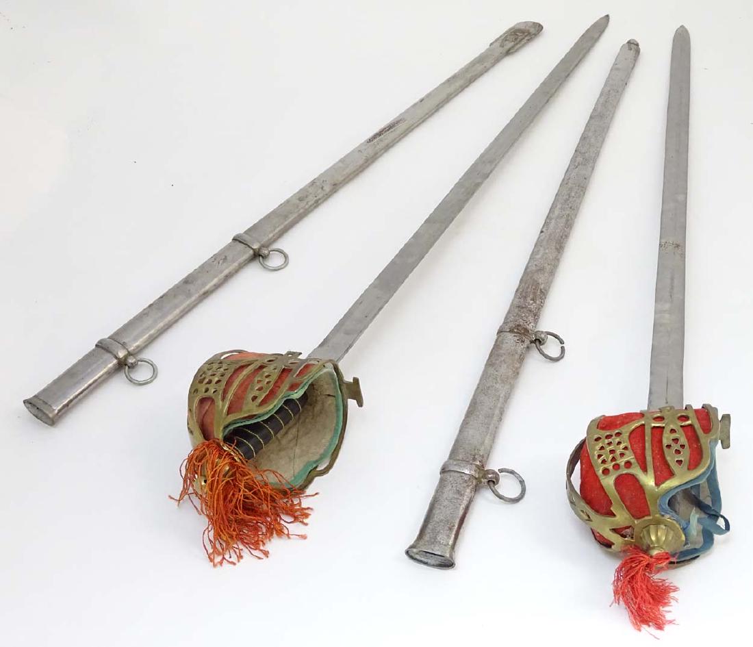 Militaria : a pair of 20thC basket - hilt swords , of