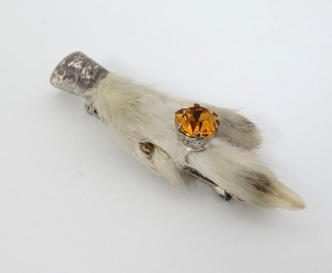 A silver mounted grouse foot brooch. Hallmarked