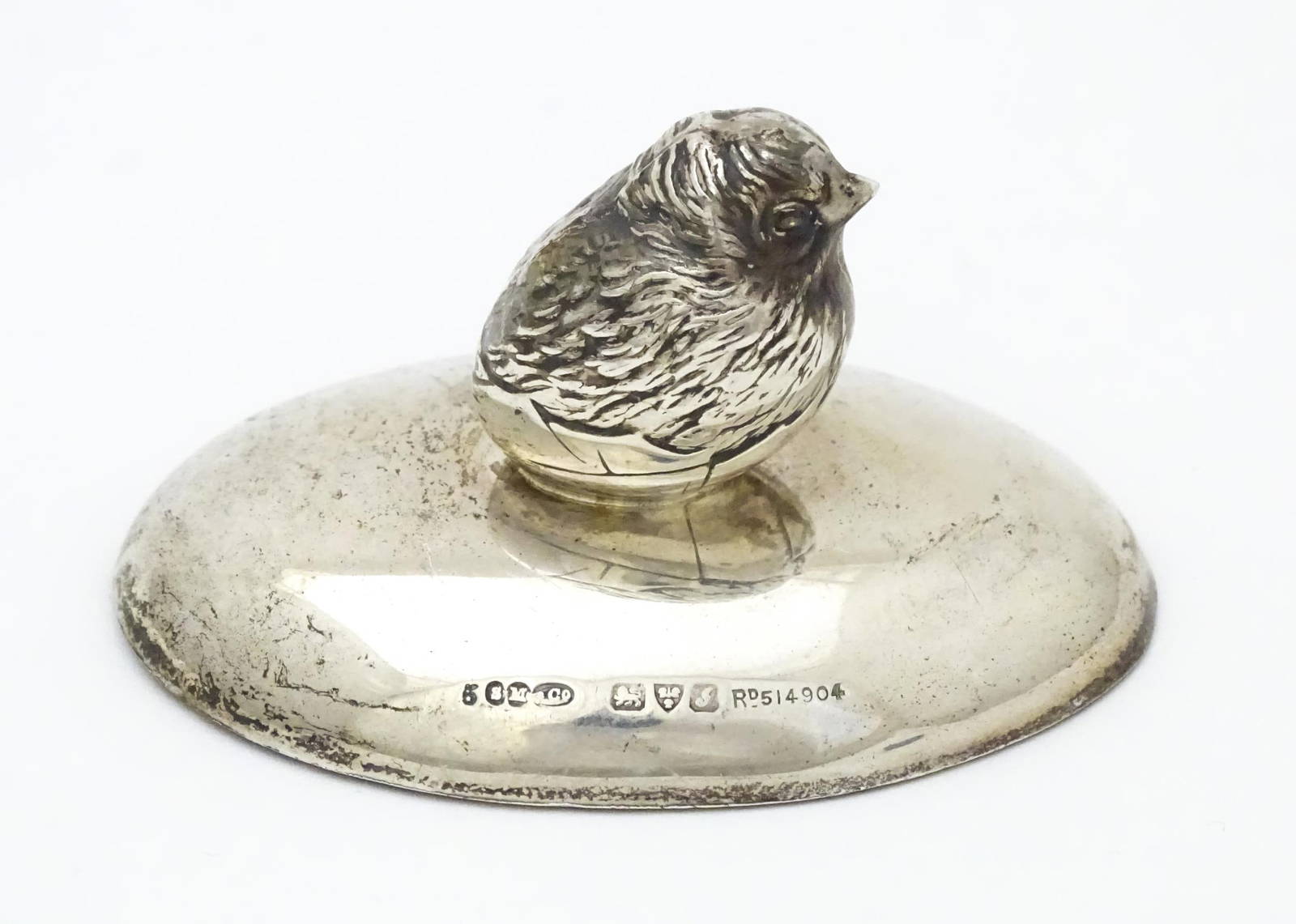 A Silver Paperweight Of Ovoid Form Surmounted By Model Of A Chick ...
