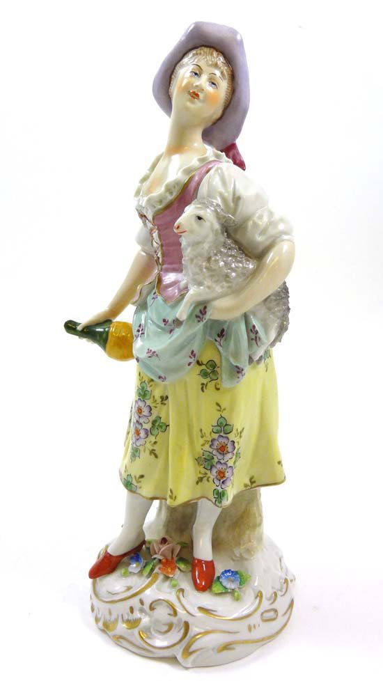 A Dresden Sitzendorf figurine of a Shepherdess wearing