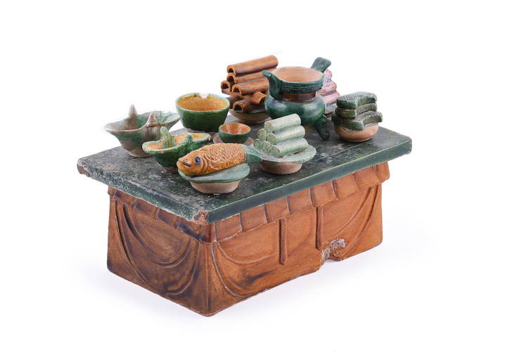 A Chinese sancai glazed pottery model of an altar table and offerings ...