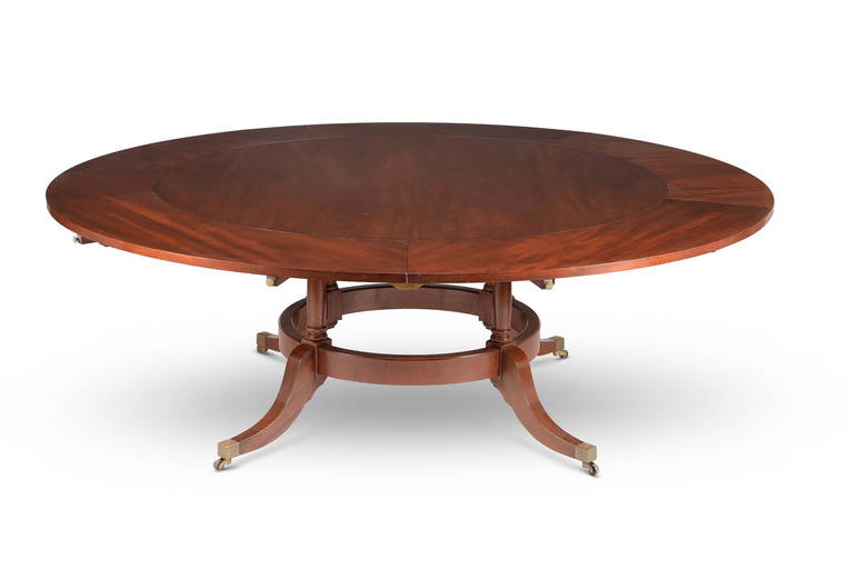 A MAHOGANY CIRCULAR CONCENTRIC EXTENDING DINING TABLE, BY ARTHUR BRETT ...