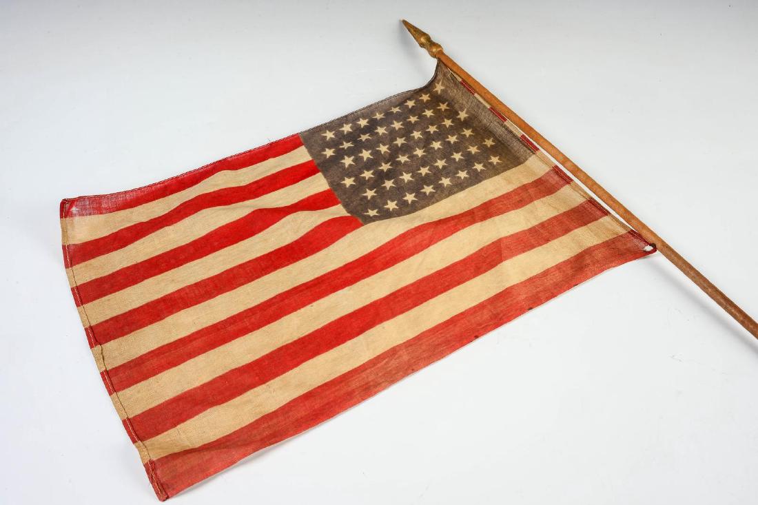 AN EARLY 20TH C. FOLK ART UNCLE SAM FLAG HOLDER