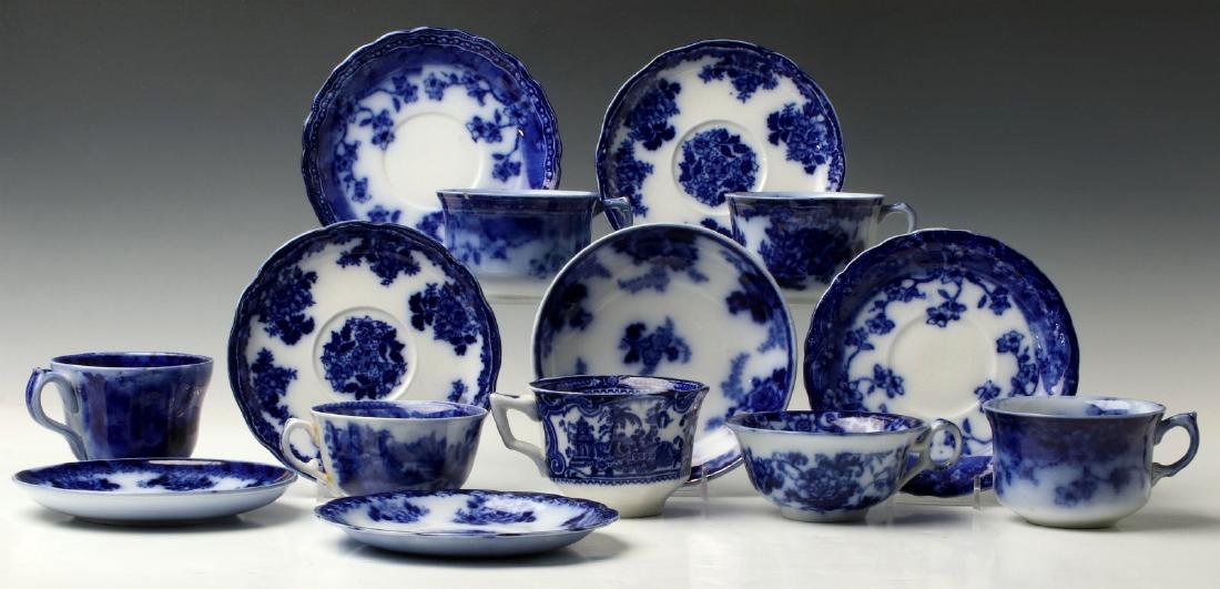 A COLLECTION OF SEVEN FLOW BLUE CUPS AND SAUCERS