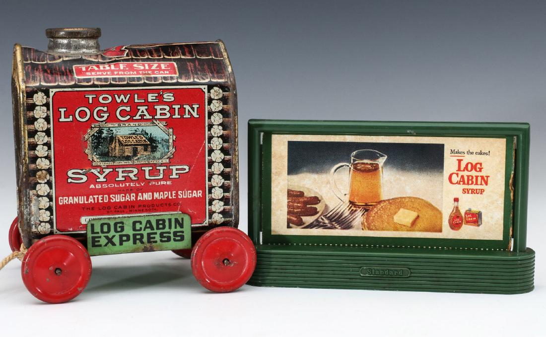 A Towles Log Cabin Syrup Tin With Pull Toy Base