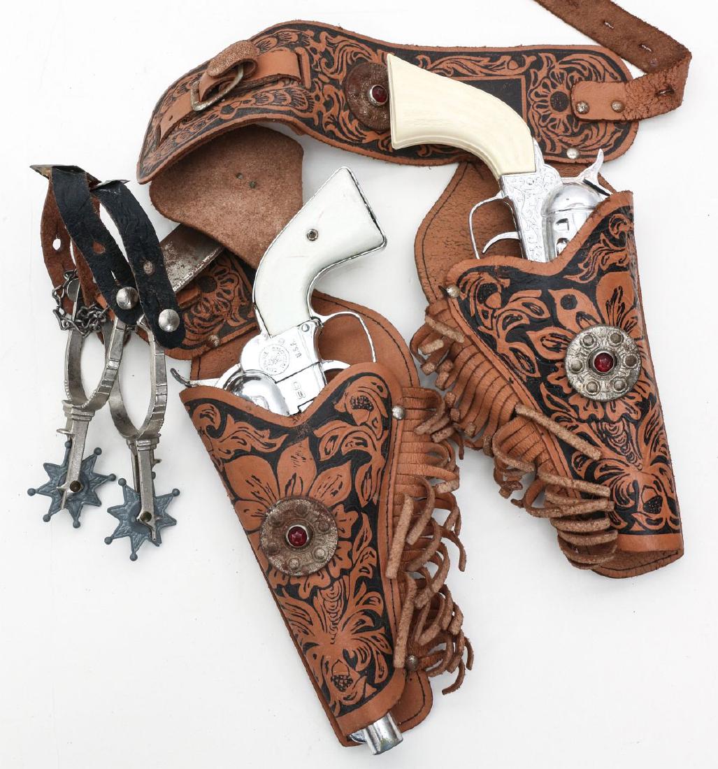 A LONE RANGER DOUBLE HOLSTER BELT, SPURS, CAP GUNS