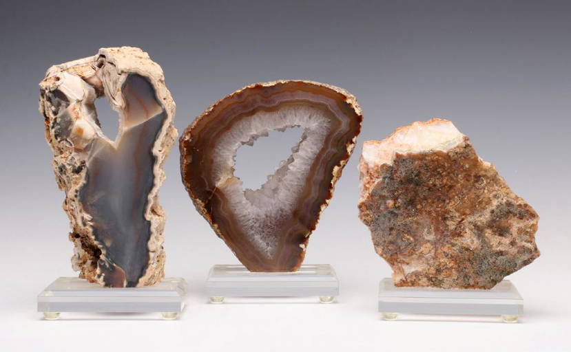 Polished Geodes And Minerals On Lucite Displays