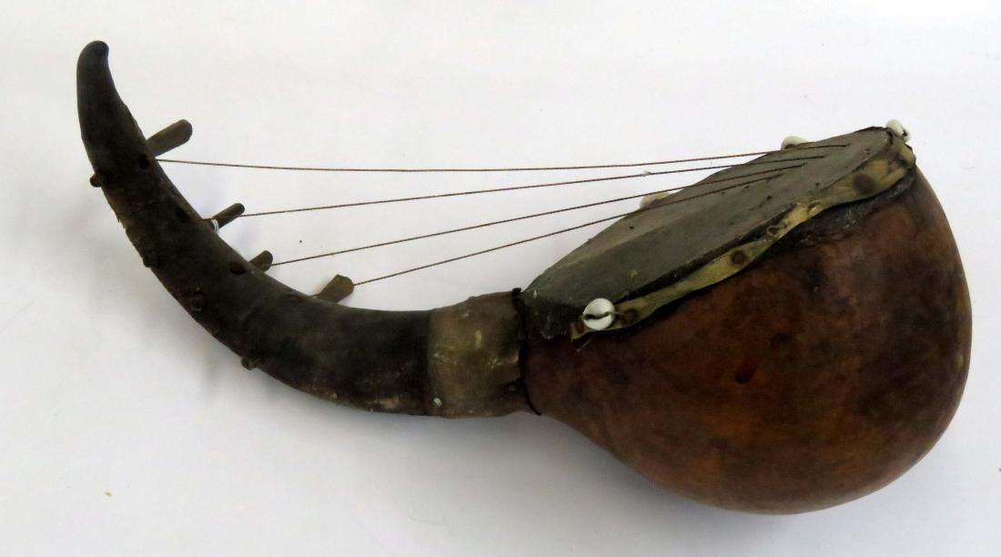 AFRICAN GOURD/HORN STRINGED INSTRUMENT. LENGTH 15"
