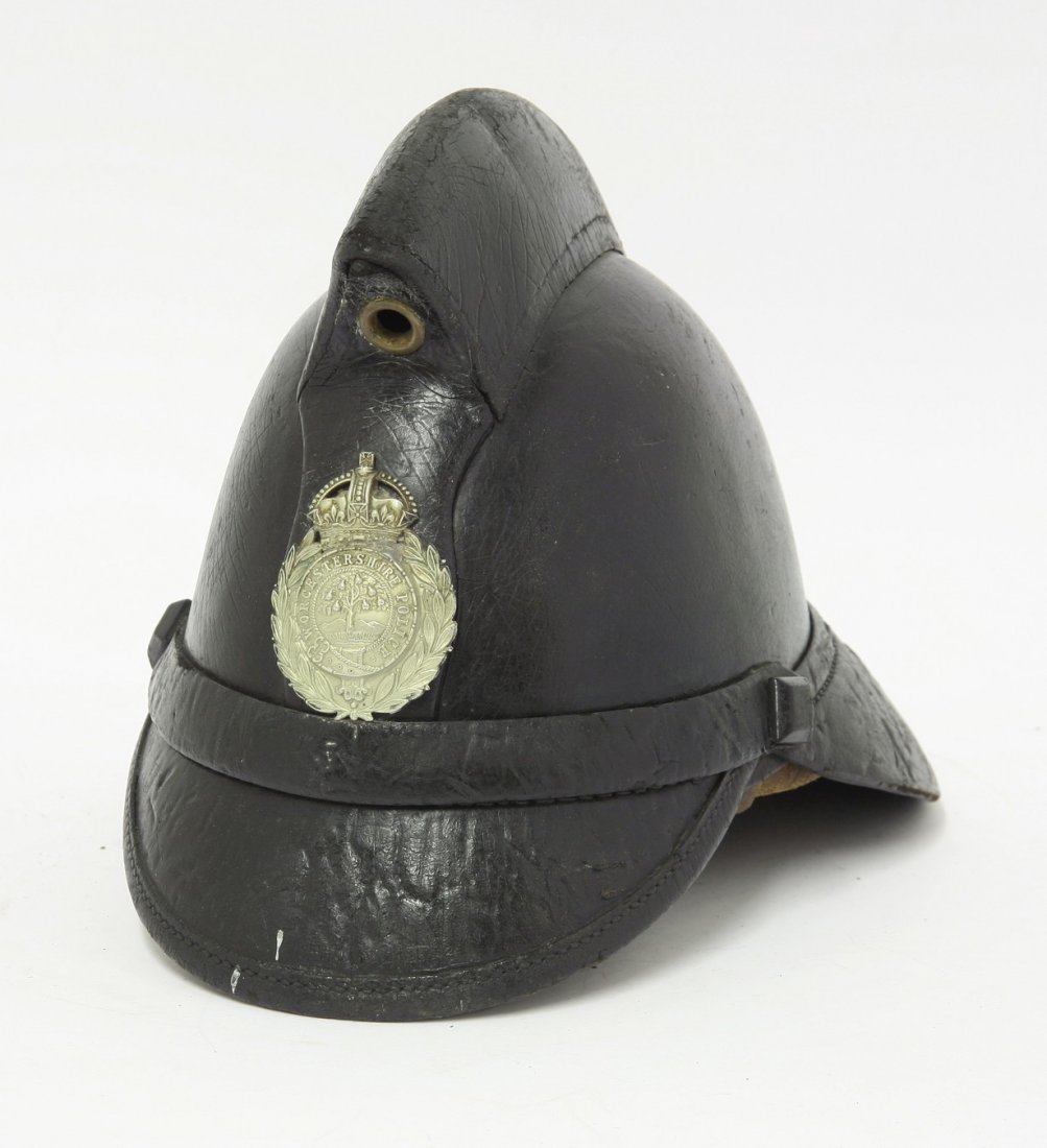 An early black leather fire helmet, with high comb,