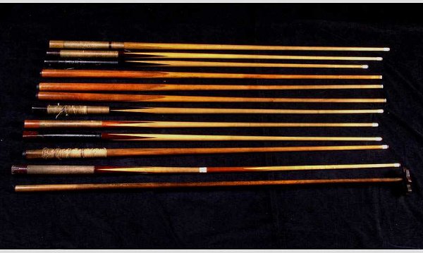 721A: 11 antique pool cues & a Brunswick cue