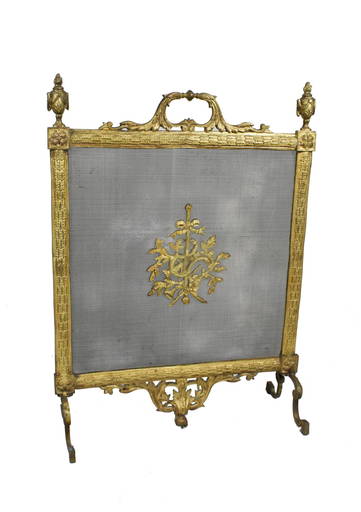 FRENCH GILT BRONZE FIRE SCREEN, The center screen set with a trophy, on ...