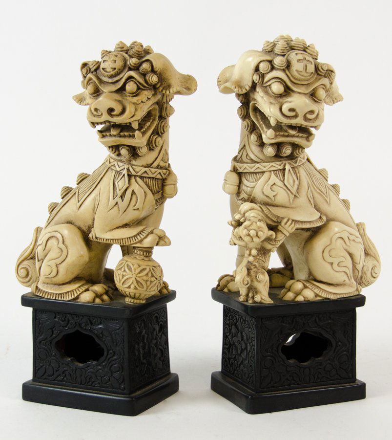 A PAIR OF CHINESE STYLE FU DOG STATUES