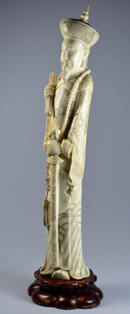 A LARGE CHINESE CARVED IVORY STATUE OF A DEITY