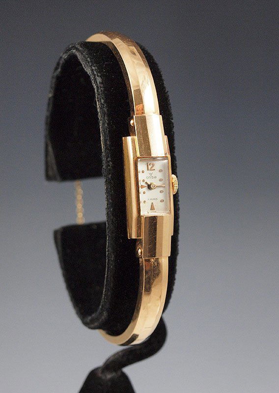 110A: ONSA LADIES 18K GOLD BANGLE WATCH CA. 1950