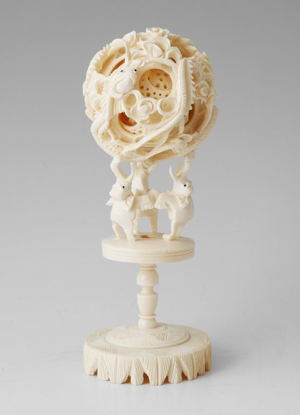 CARVED IVORY MYSTERY BALL ON STAND