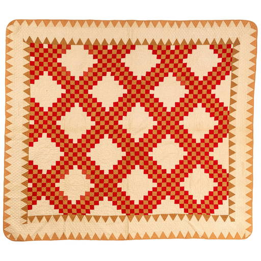 A Diamond Cross Pattern Quilt In Red And Brown