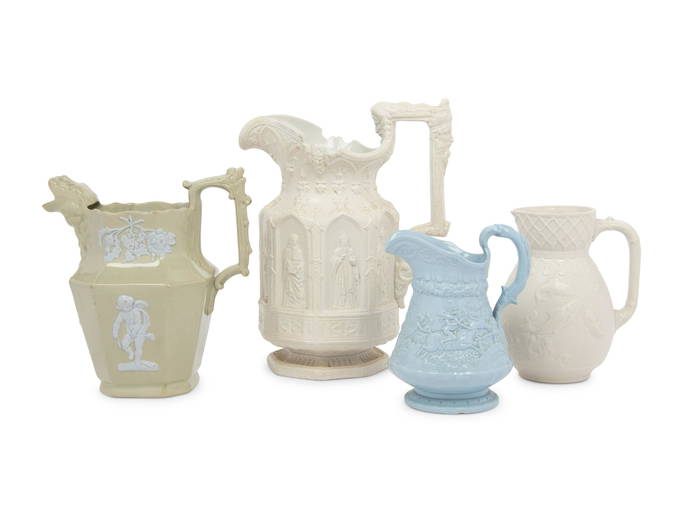 Four English Molded And Glazed Pottery Pitchers