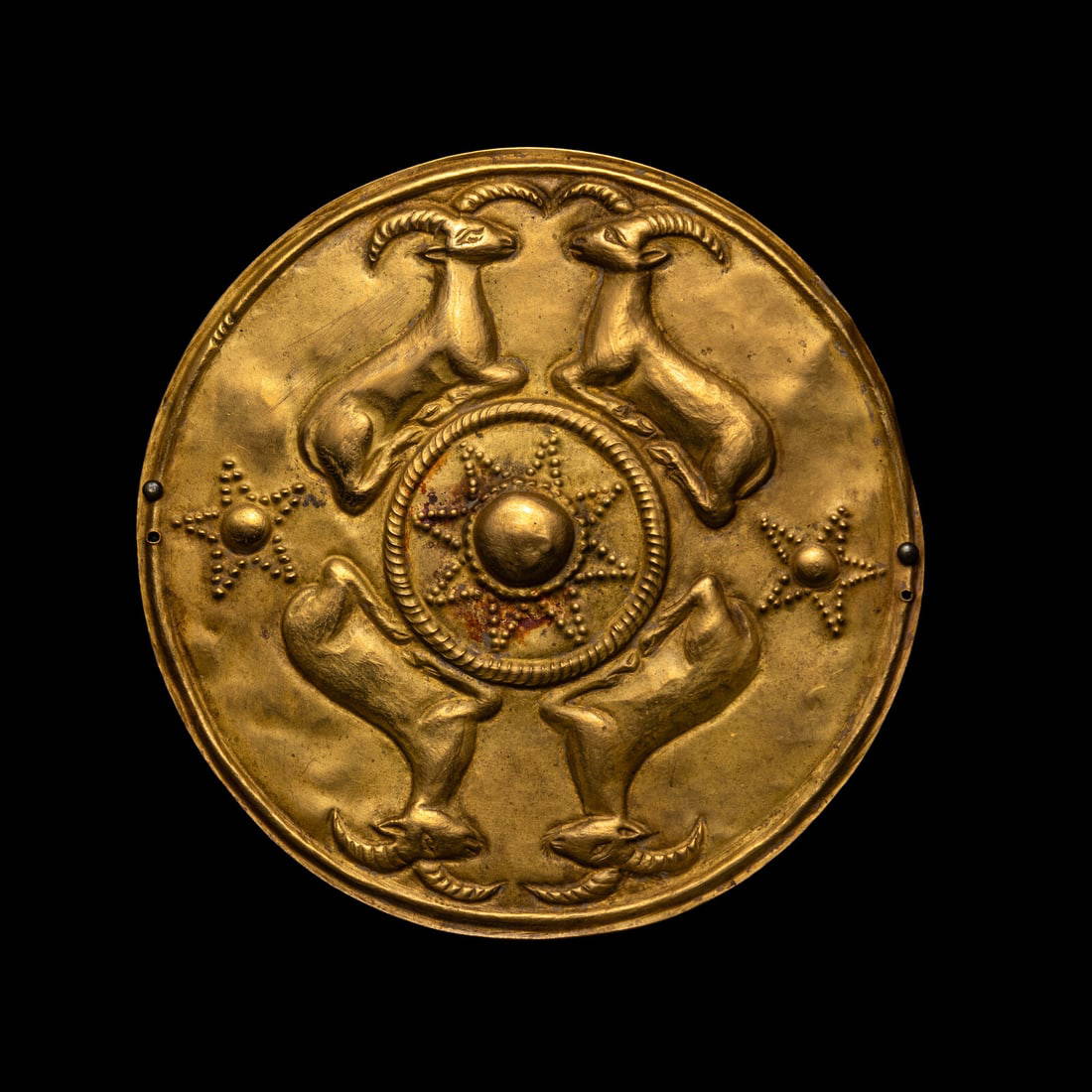 A Near East Gold Disk With Four Recumbent Rams Auction