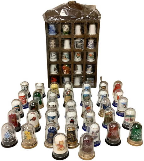 Lot of 57 thimbles. 20 in wooden showcase. 37 in individual one holders ...