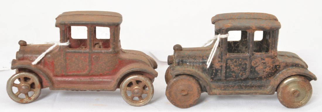 Two Early Cast Iron Automobiles, One Spoke, One Solid