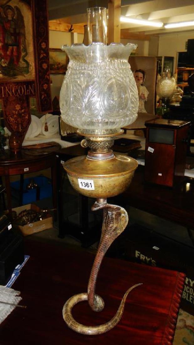 A brass oil lamp in the form of a cobra snake