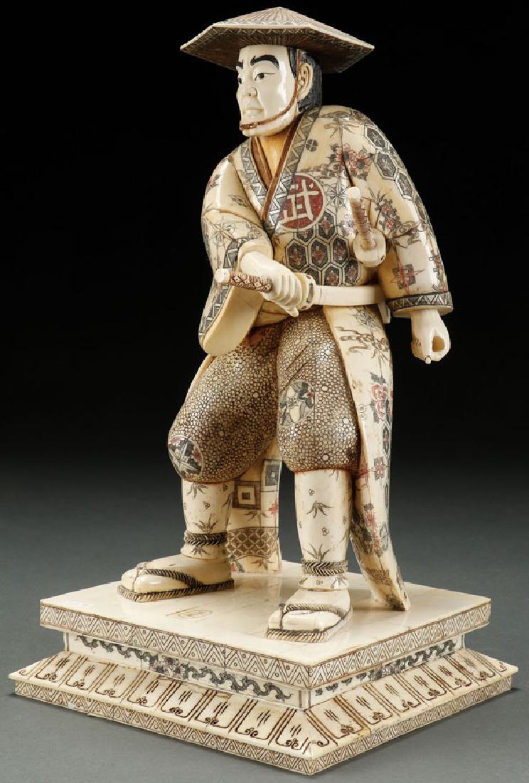 A LARGE JAPANESE CARVED BONE FIGURE OF A SAMURAI