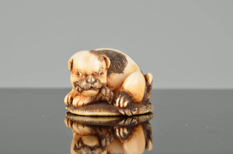 Japanese Carved Netsuke Of A Dog With A Toy