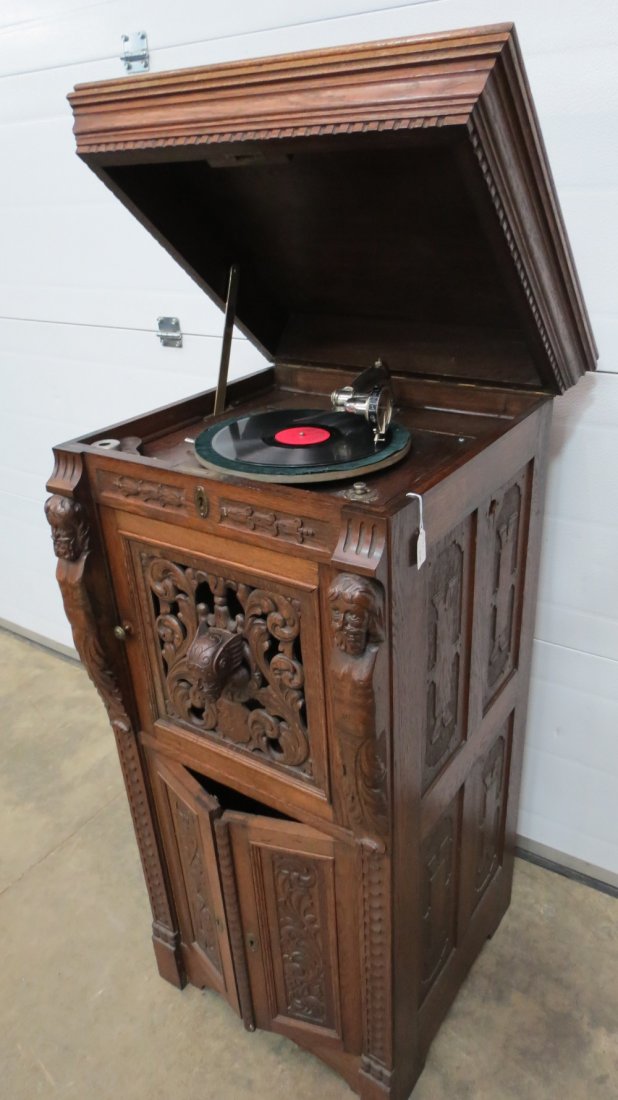A carved oak Parlophon cabinet gramophone with a
