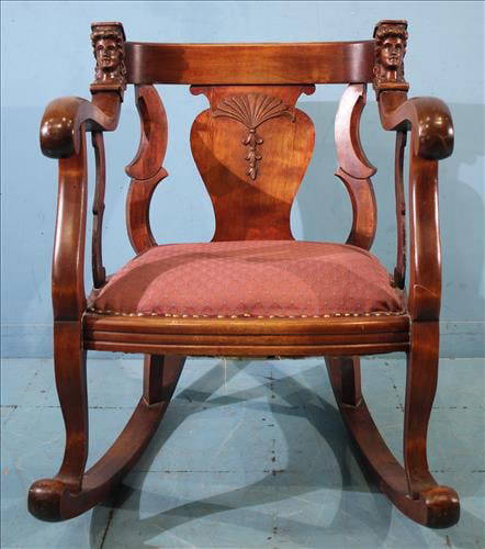 Mahogany Rocker With Figure Of Heads And Mauve Upholstery