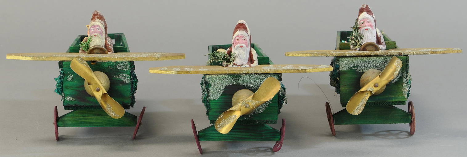 Three Contemporary Santa In Airplane