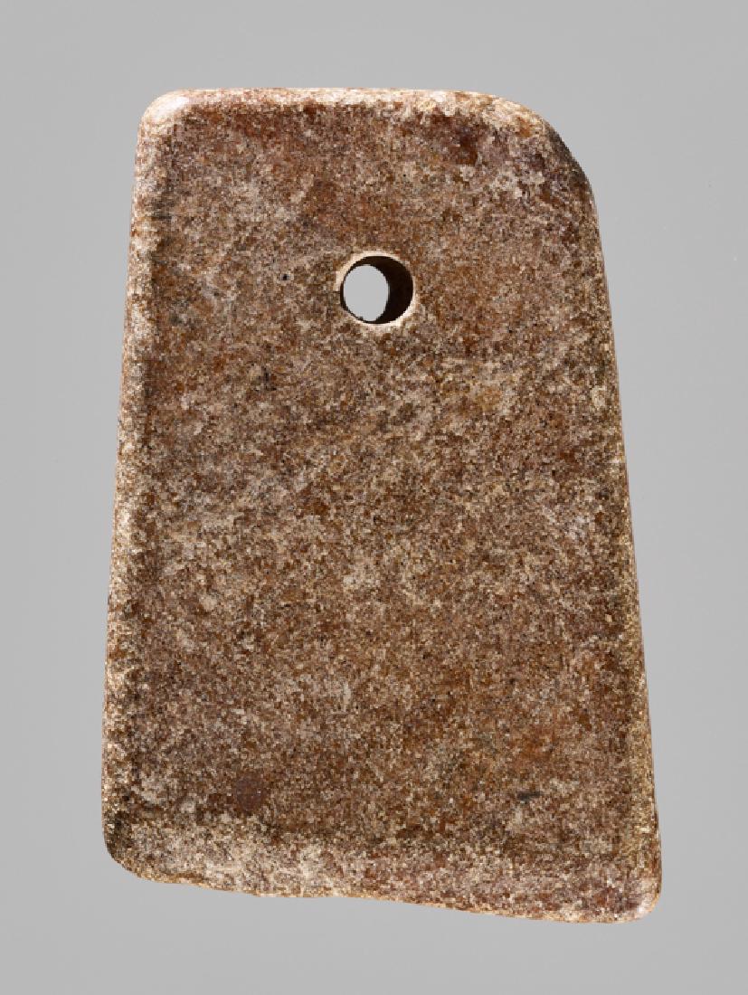 A BROWN MOTTLED STONE AXE BLADE 'FU'