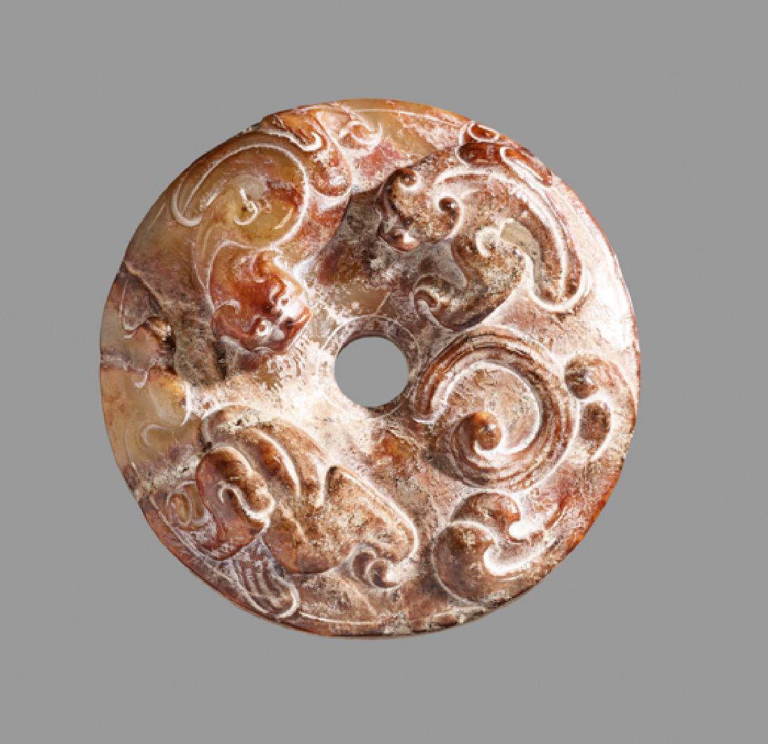 A STRIKING SWORD POMMEL WITH A PAIR OF DRAGONS