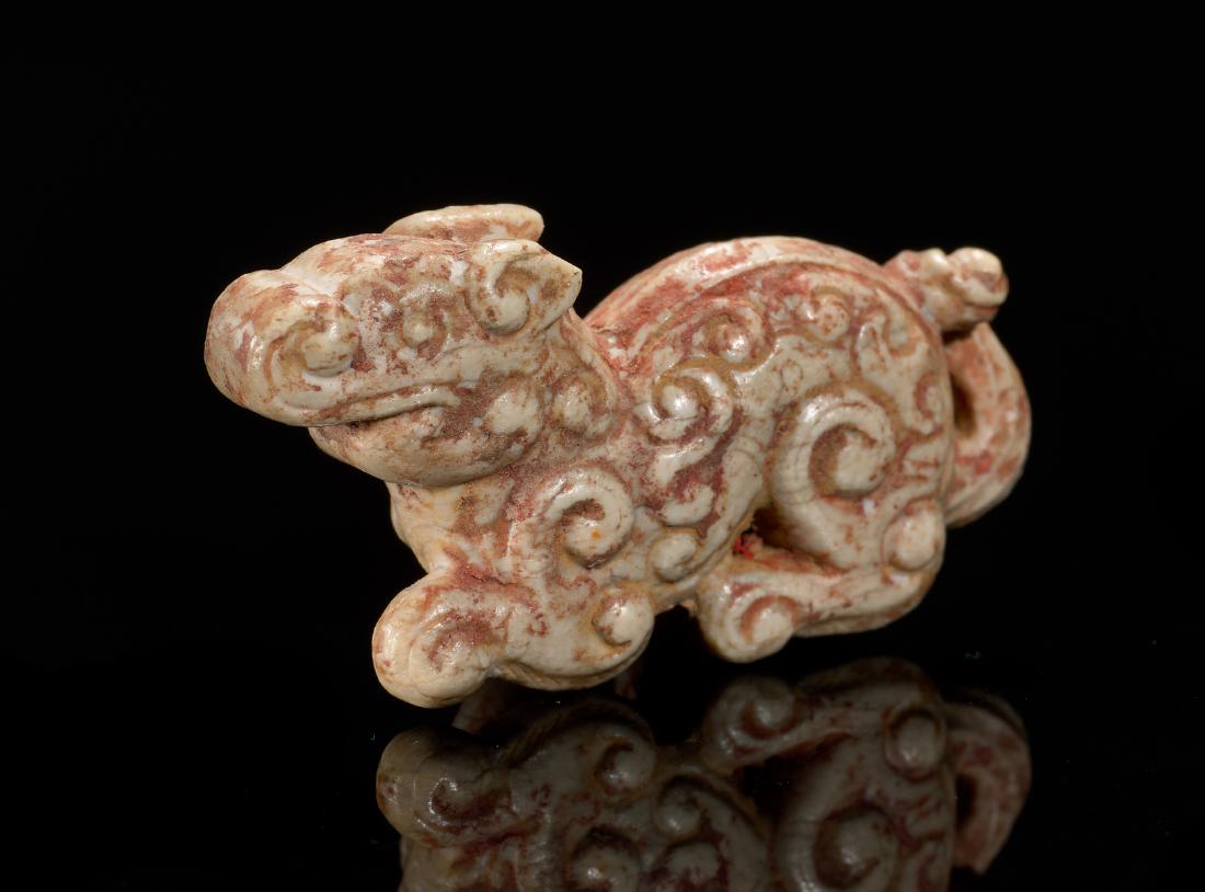 CROUCHING ANIMAL WITH PATTERN OF CARVED CURLS