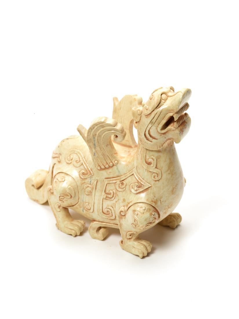 A HAN DYNASTY STYLE JADE FIGURE IN THE SHAPE OF A BIXIE