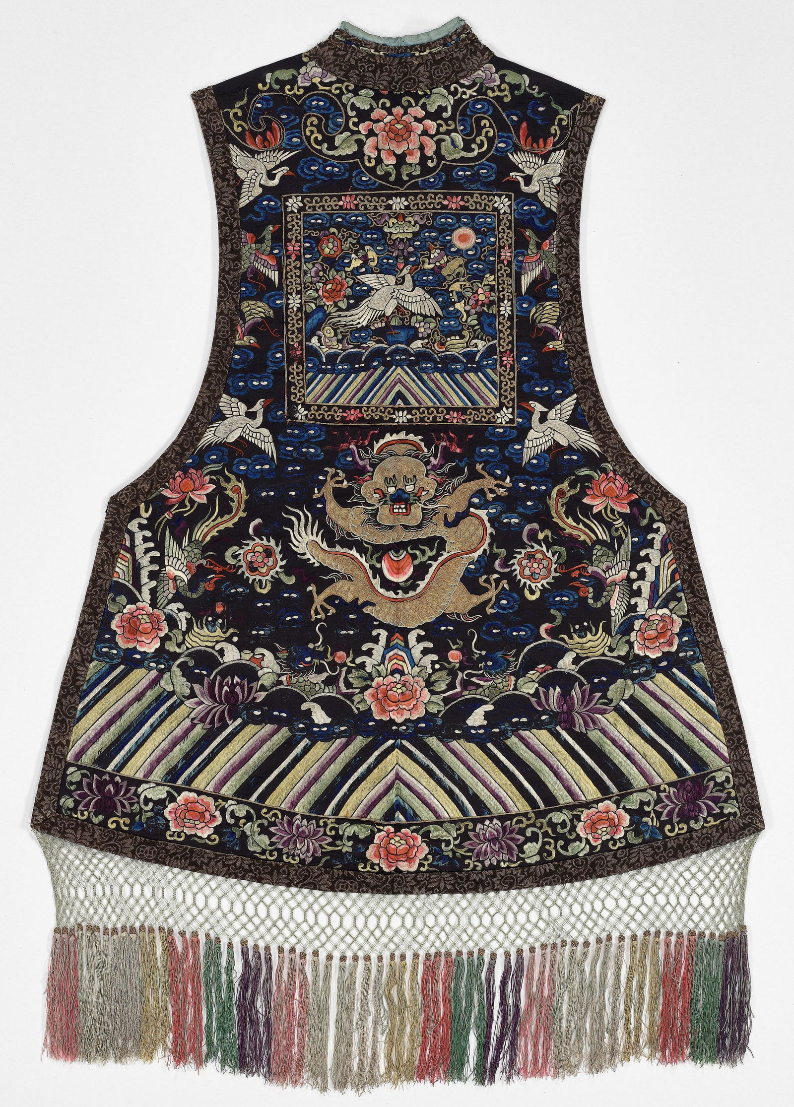 A SEMI-OFFICIAL EMBROIDERED SILK VEST AND RANK BADGE, LATE QING DYNASTY ...